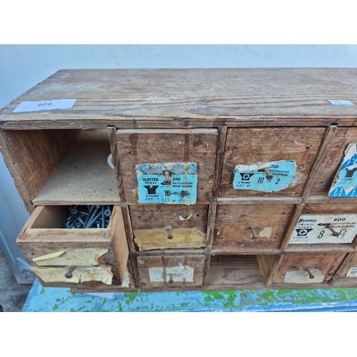 A rustic workshop desk tidy with various screws and fixings