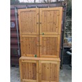 A pine storage unit - 2 cupboard spaces with a large singular storage ...