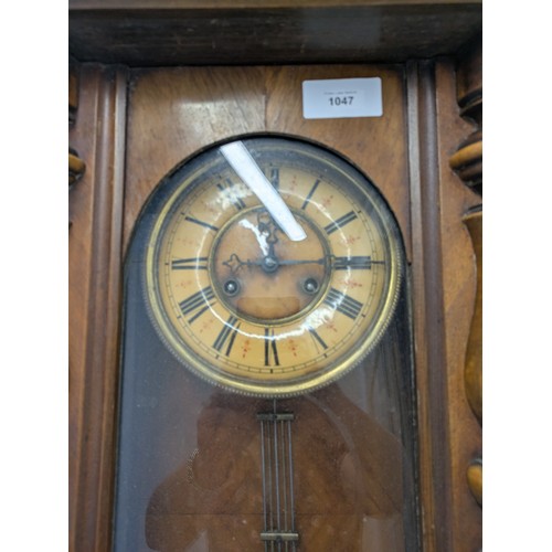 A Victorian mahogany wall mounted pendulum clock
