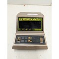A retro Tomy Grandatan Caveman handheld game console