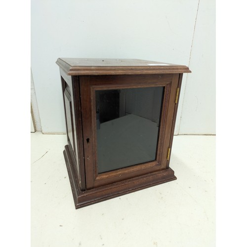 A small mahogany cube display unit with a bevelled glass front
