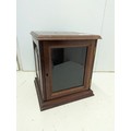 A small mahogany cube display unit with a bevelled glass front