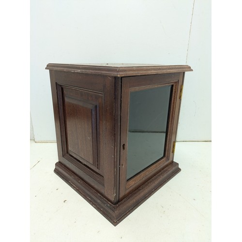 A small mahogany cube display unit with a bevelled glass front