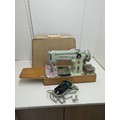 A singer 319k sewing machine with pedal cams and accessories in case