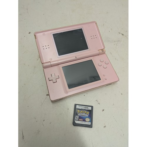 A pink Nintendo ds lite console - with Pokémon diamond game