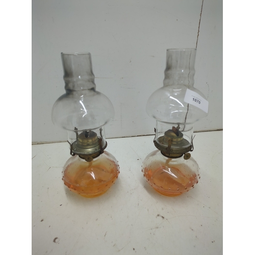 A pair of vintage paraffin lamps