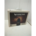 A Nespresso Essence mini coffee machine in box