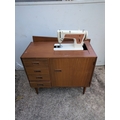 A singer model 239 sewing machine in cabinet