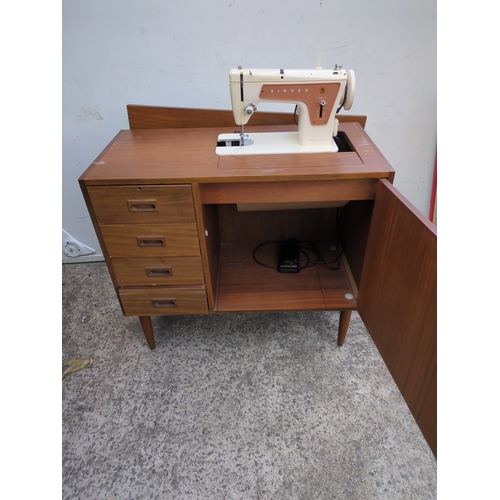 A singer model 239 sewing machine in cabinet