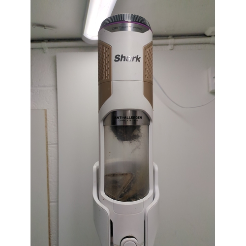 A shark model iw3611 ukt cordless vacuum cleaner with charger - Powers on