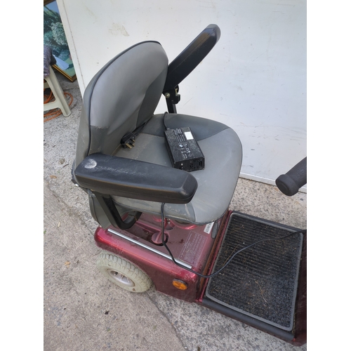 A Shoprider mobility scooter with keys and charger