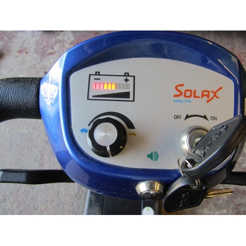 A Solax mobility scooter with folding framework with charger