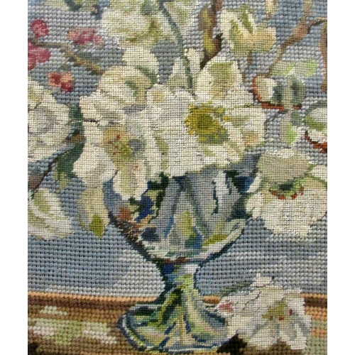 A late 18th century petit point needlework, depicting a vase and floral ...