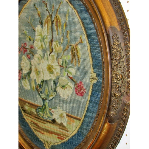 A late 18th century petit point needlework, depicting a vase and floral ...
