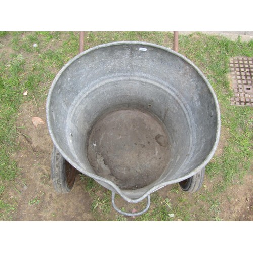 A vintage two wheeled water barrow, the iron frame supporting a ...