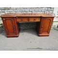 A Victorian mahogany inverted breakfront desk with two central drawers ...