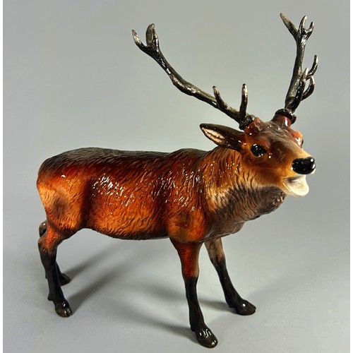 A collection of ceramic figures comprising a Royal Doulton Stag, a ...