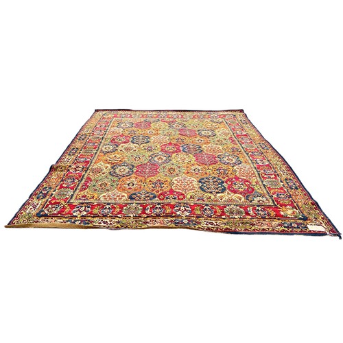 An old Axminster type machine made carpet with a bold floral pattern ...