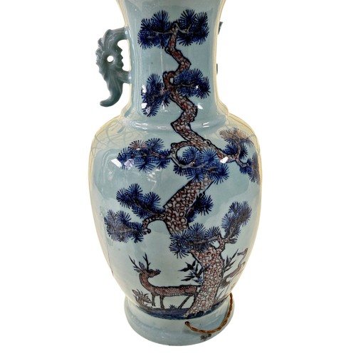 A large modern Chinese celadon vase converted into a lamp, with ...