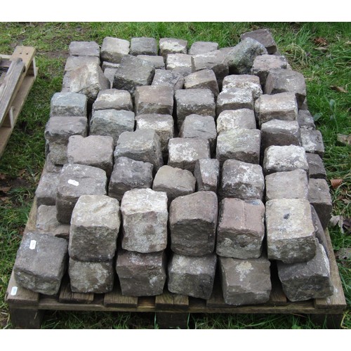 Approximately a hundred reclaimed granite cobble stones contained on a ...