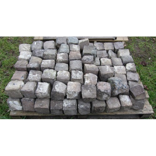 Approximately a hundred reclaimed granite cobble stones contained on a ...