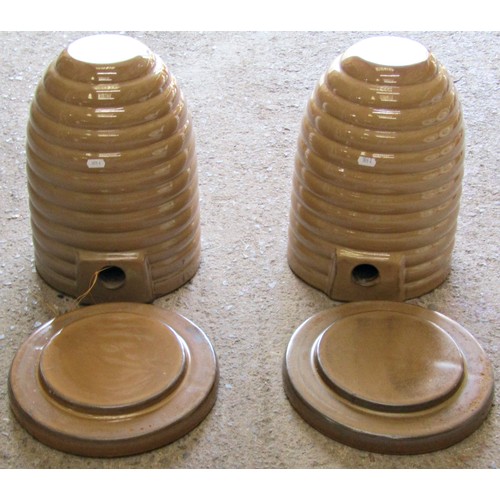 A pair of decorative glazed ceramic beehives / skeps, of traditional ...