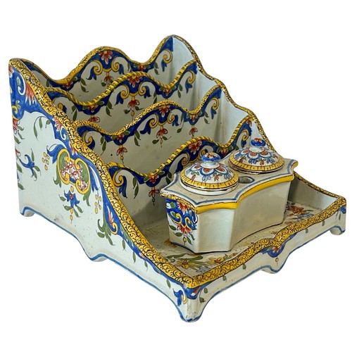 A Quimper tin-glazed desk stand of segmented tapering form complete ...