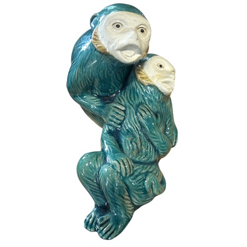 Two Chinese porcelain figures, one of Monkeys, the other a dragon ...