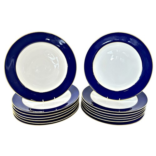 Fourteen large blue and gilt bordered dinner plates, 31cm diameter