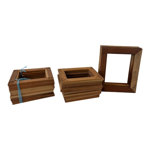 A collection of twenty-five carved wooden picture frames, of varying ...