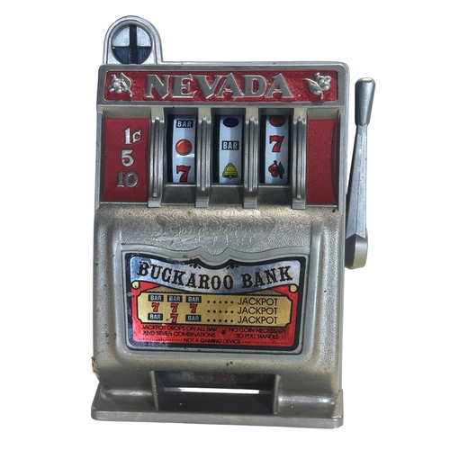 A Nevada 'Buckaroo Bank' miniature one armed bandit, together with a ...