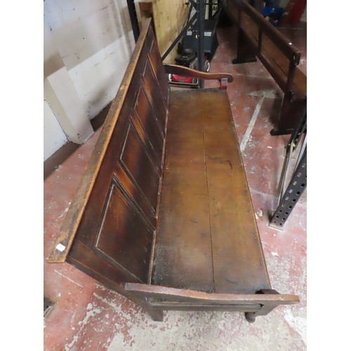 A Georgian oak country made settle, the back incorporating five fielded ...