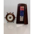 A ships wheel mounted with a barometer and a hall mirror with a clothes ...