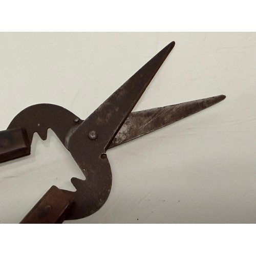 Kitchenalia, a pair of wrought iron scissors with hard wood handles ...