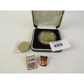 two collectable football coins and badges