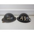Two WWII ARP and police helmets