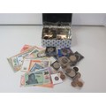 Tin full of various coins and banknotes
