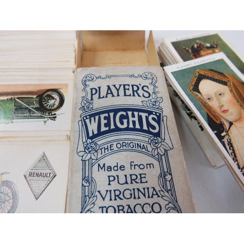 Two cigarette packets full of cigarette cards
