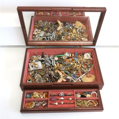 Vintage wooden jewellery box full of jewellery.