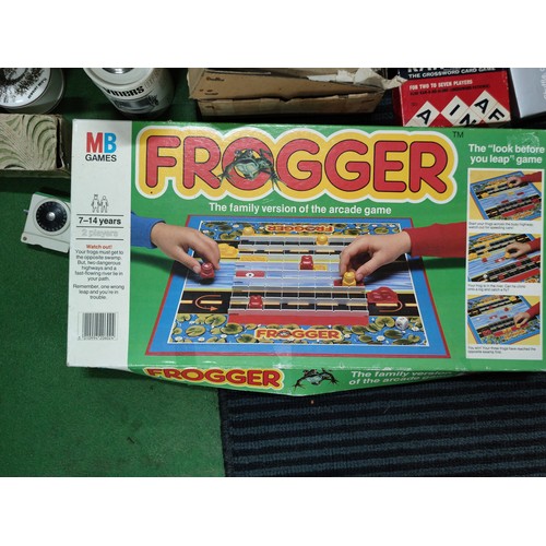A box containing a quantity of board games including frogger, along ...