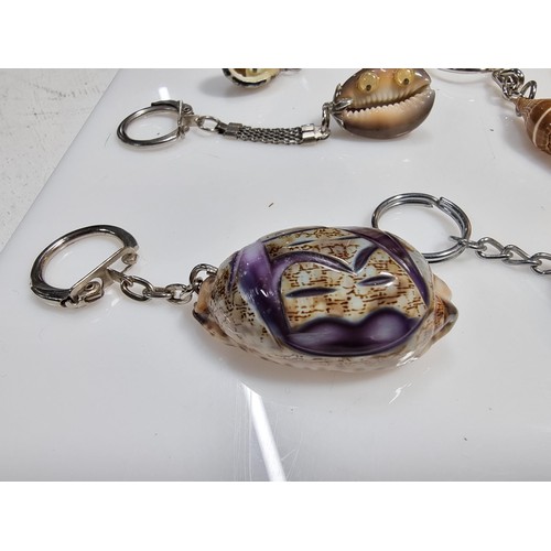 A collection of 15 x shell keyrings including 2 very well carved cowrie ...