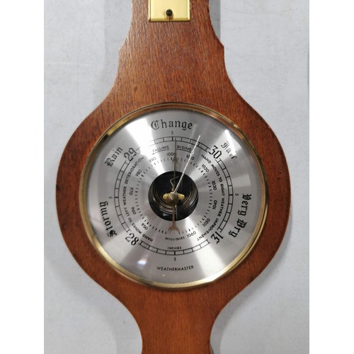 Modern barometer with a thermometer along with a bevel glass mirror ...