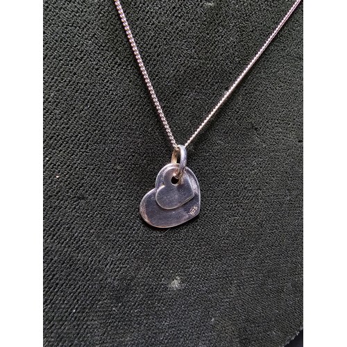 A 925 silver double heart pendant set on an 18" 925 silver chain, in ...