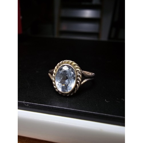 A quality vintage 925 silver dress ring inset with a large faceted blue ...