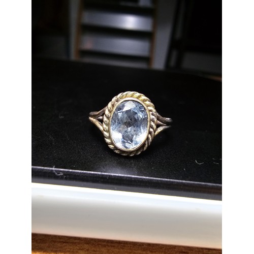 A quality vintage 925 silver dress ring inset with a large faceted blue ...