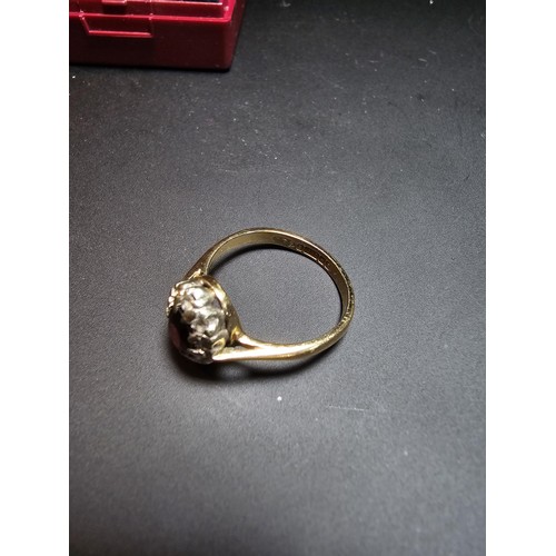 A hallmarked 9ct yellow gold ring inset with a large garnet stone ...