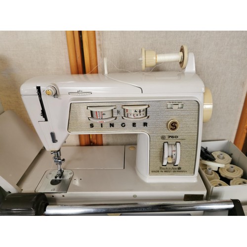 A cased vintage Singer electric sewing machine complete with a large ...