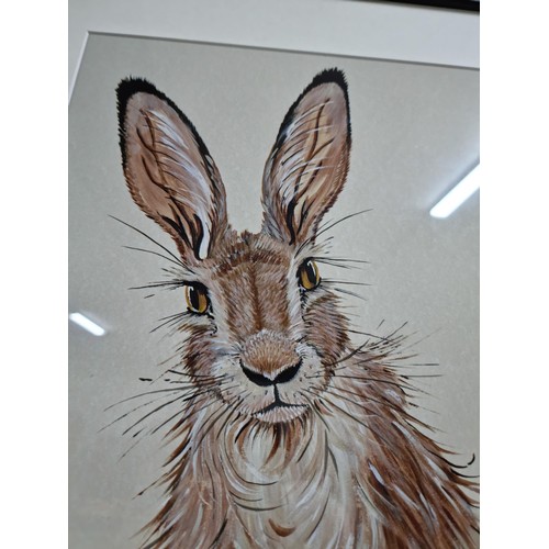 A framed and glazed print of a brown hare by Katherine Harvey titled ...