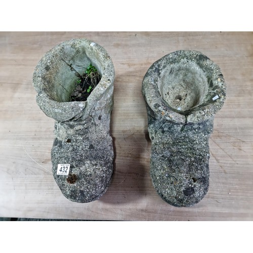 Pair of concrete boot formed planters in good order both are weather ...