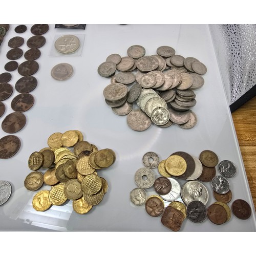 A very large quantity of mostly British coins organized in to 6 bags to ...